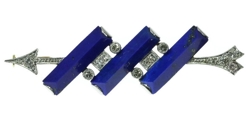 Diamond arrow brooch perforating three solid bars of lapis lazuli ...